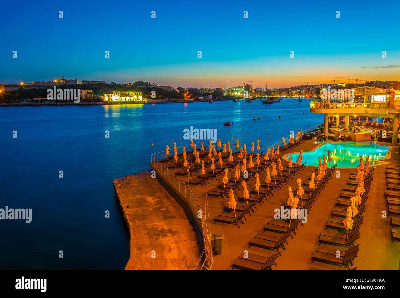 Night view of a bar with a swimming pool in Sliema, Malta Stock Photo ...