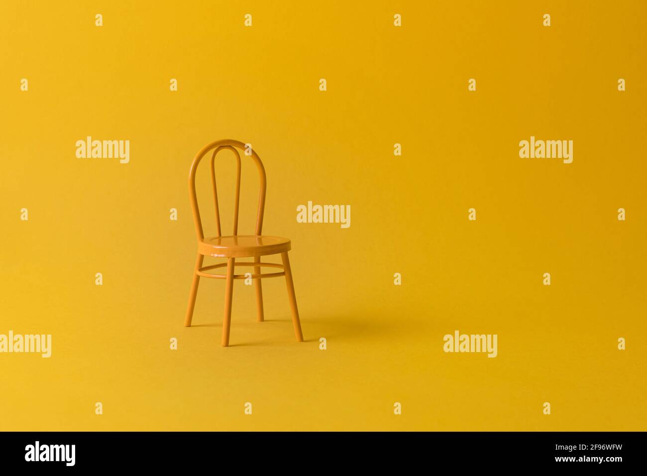 Vintage yellow chair on a yellow background. Copy space. Minimal ...