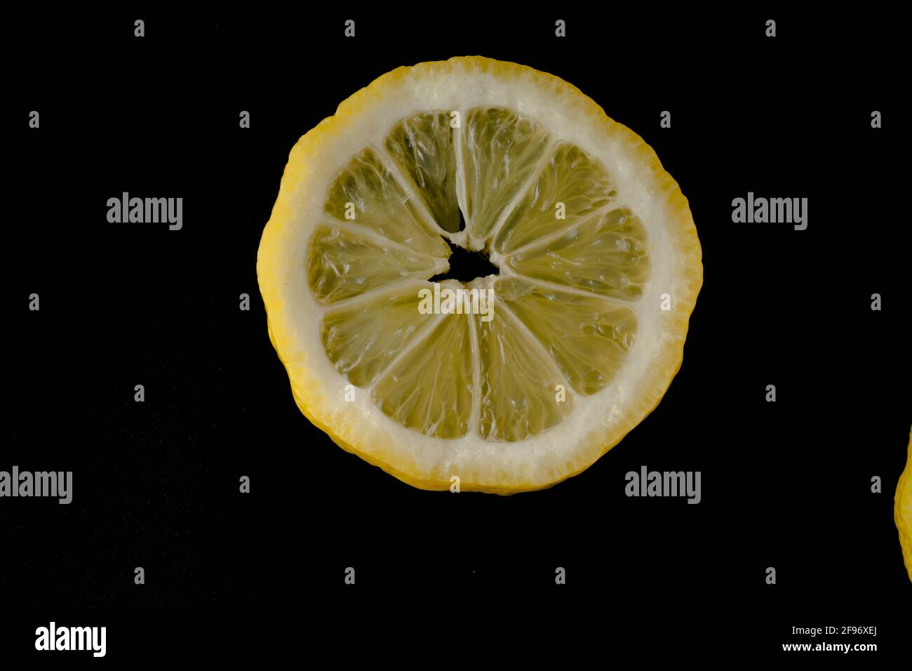 Five lemon slices lined up in a semicircle on a black background Stock ...