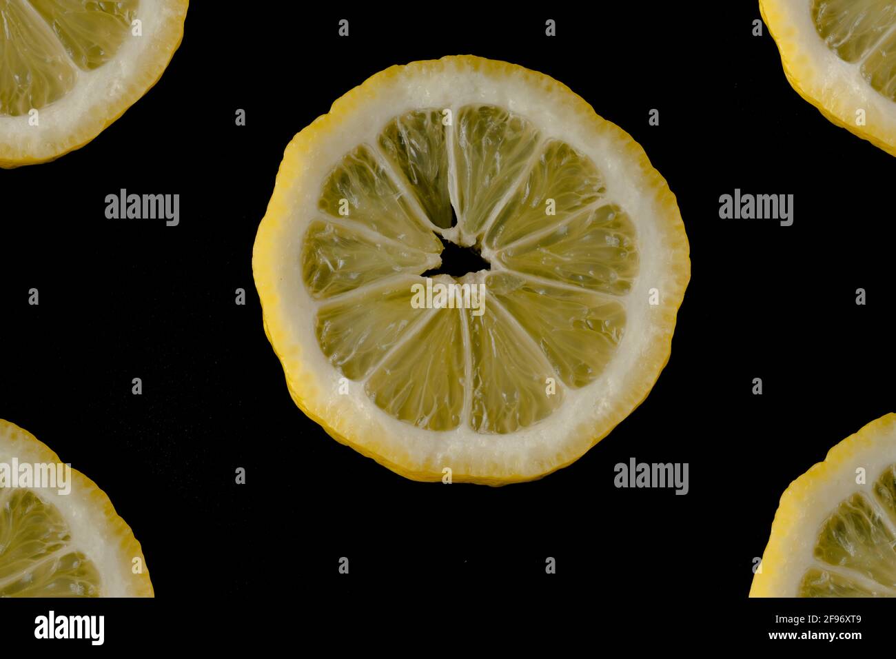 Five lemon slices lined up in a semicircle on a black background Stock ...