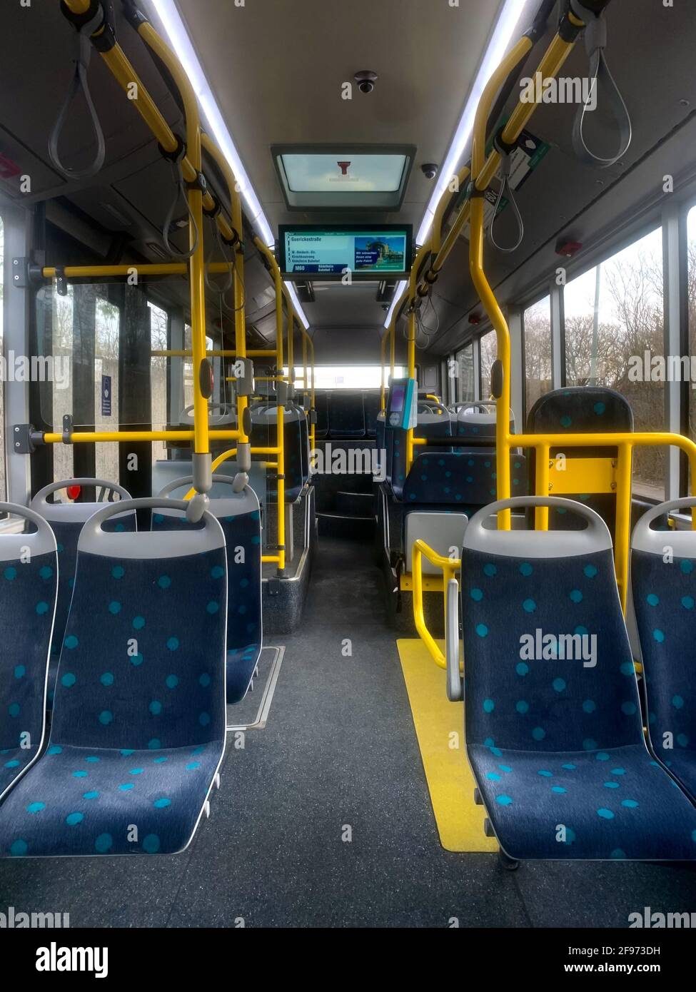 Interior of an empty bus yellow hand railings and blue seats Stock ...