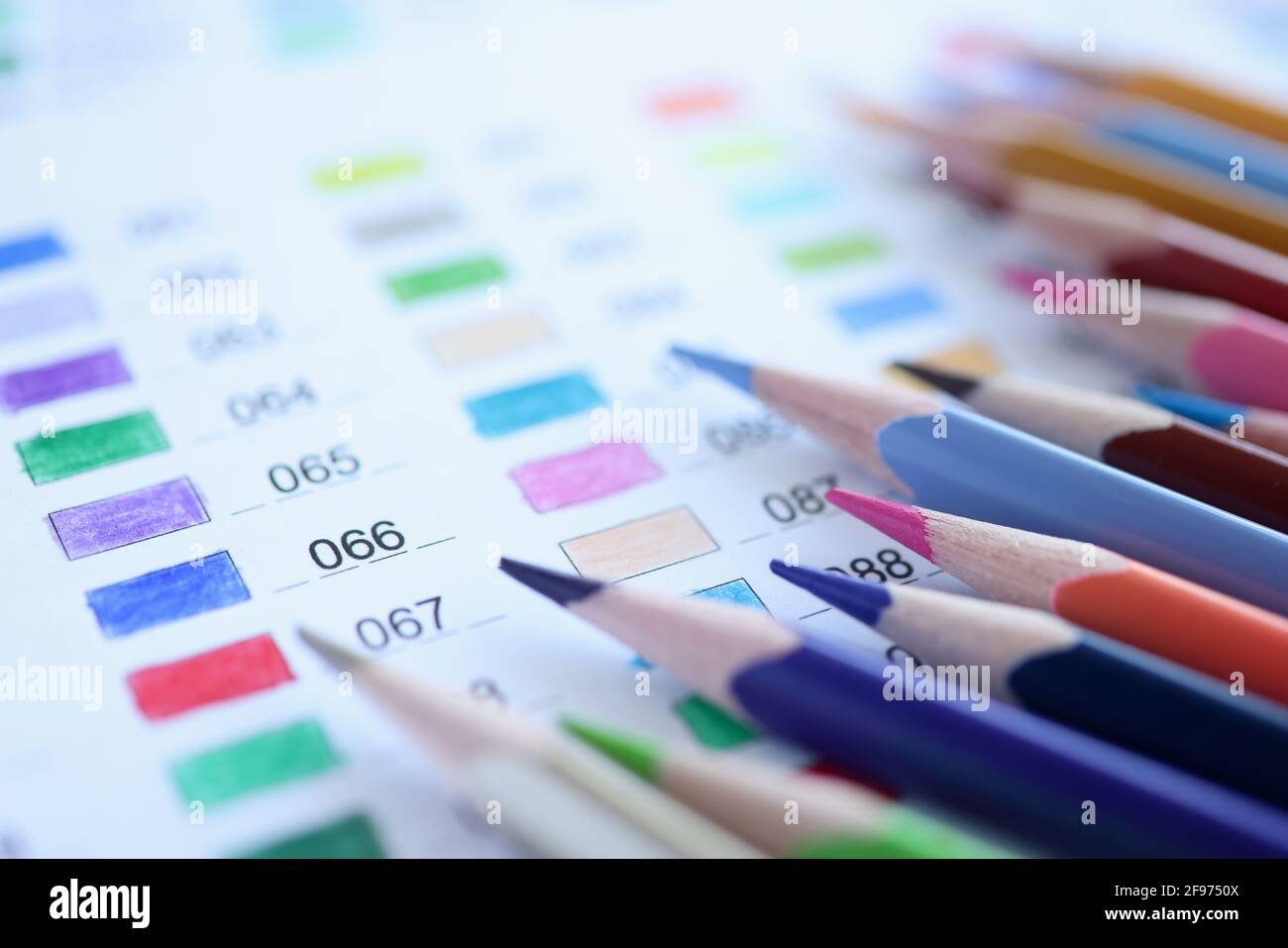Colored pencils are on color palette with numbers Stock Photo - Alamy