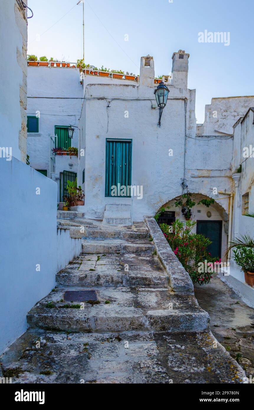 View of a white narrow street in the Italian city Ostuni Stock Photo ...