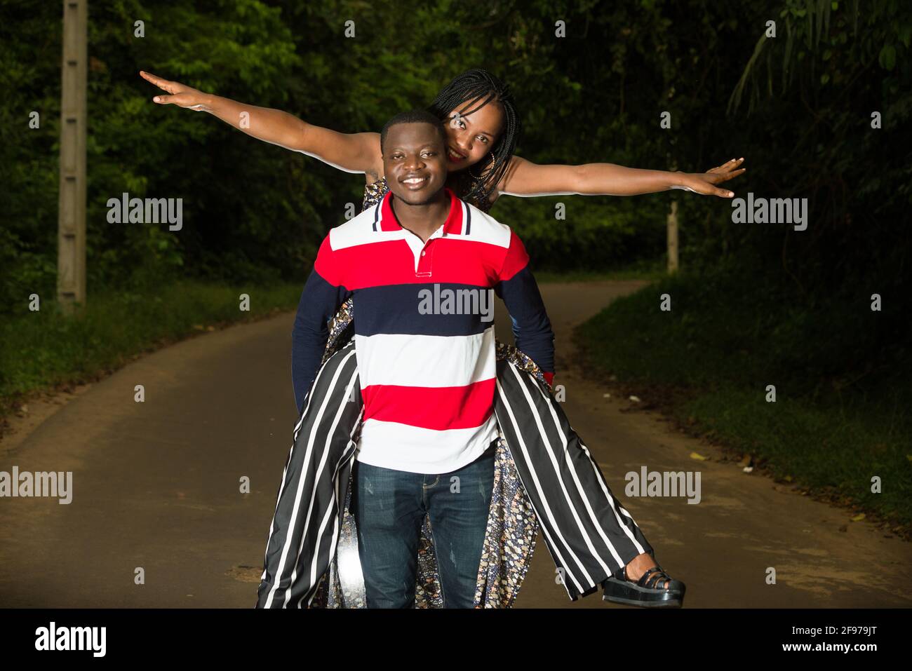 happy young man carrying his companion also happy Stock Photo - Alamy