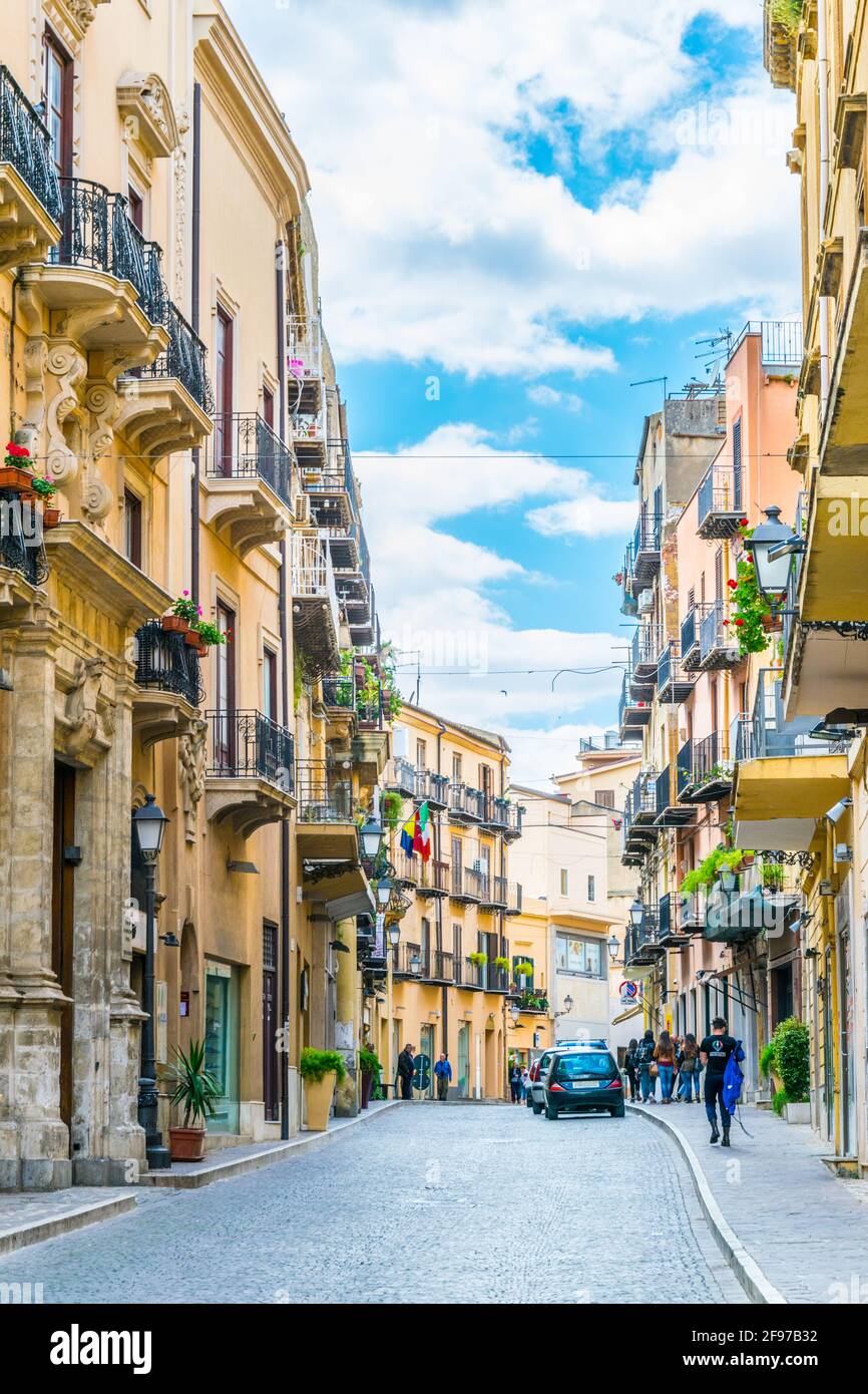 View of a narrow street in the historical city of Agrigento in Sicily ...