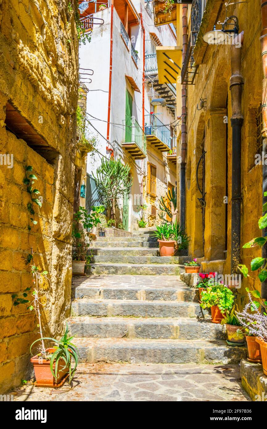 View of a narrow street in the historical city of Agrigento in Sicily ...