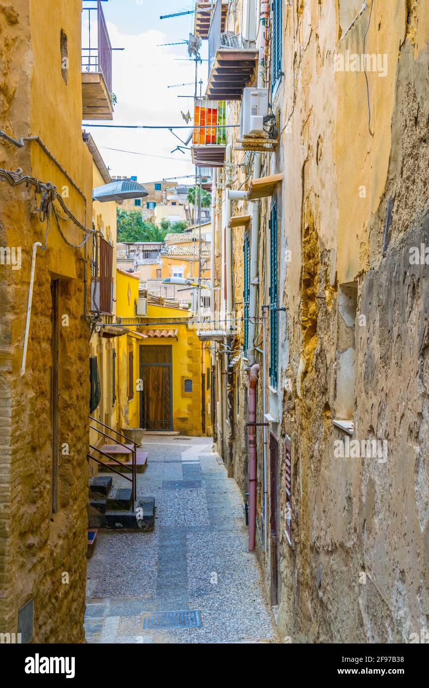 View of a narrow street in the historical city of Agrigento in Sicily ...