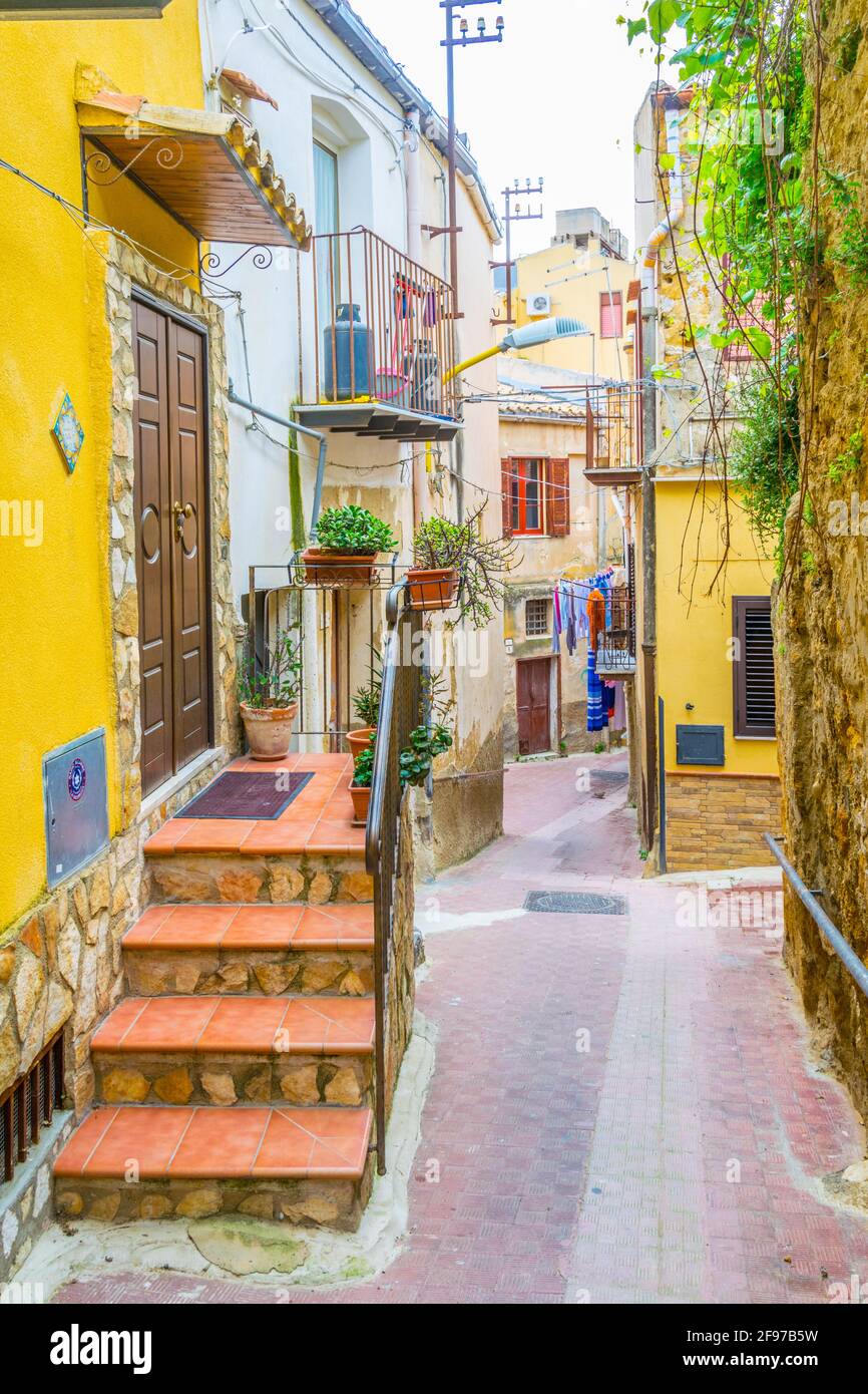 View of a narrow street in the historical city of Agrigento in Sicily ...
