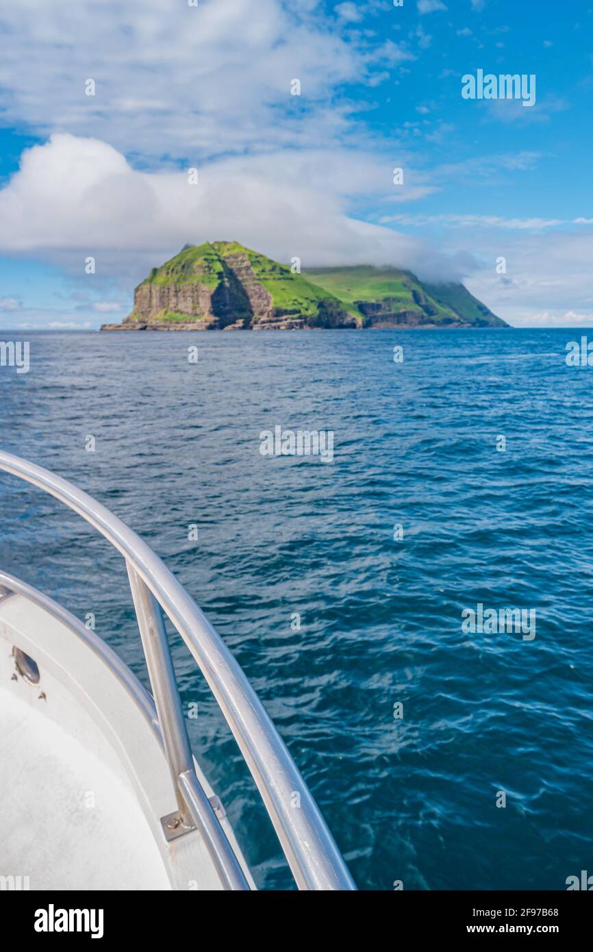 Touristic ship is going towards Mykines island with puffins at Faroe ...
