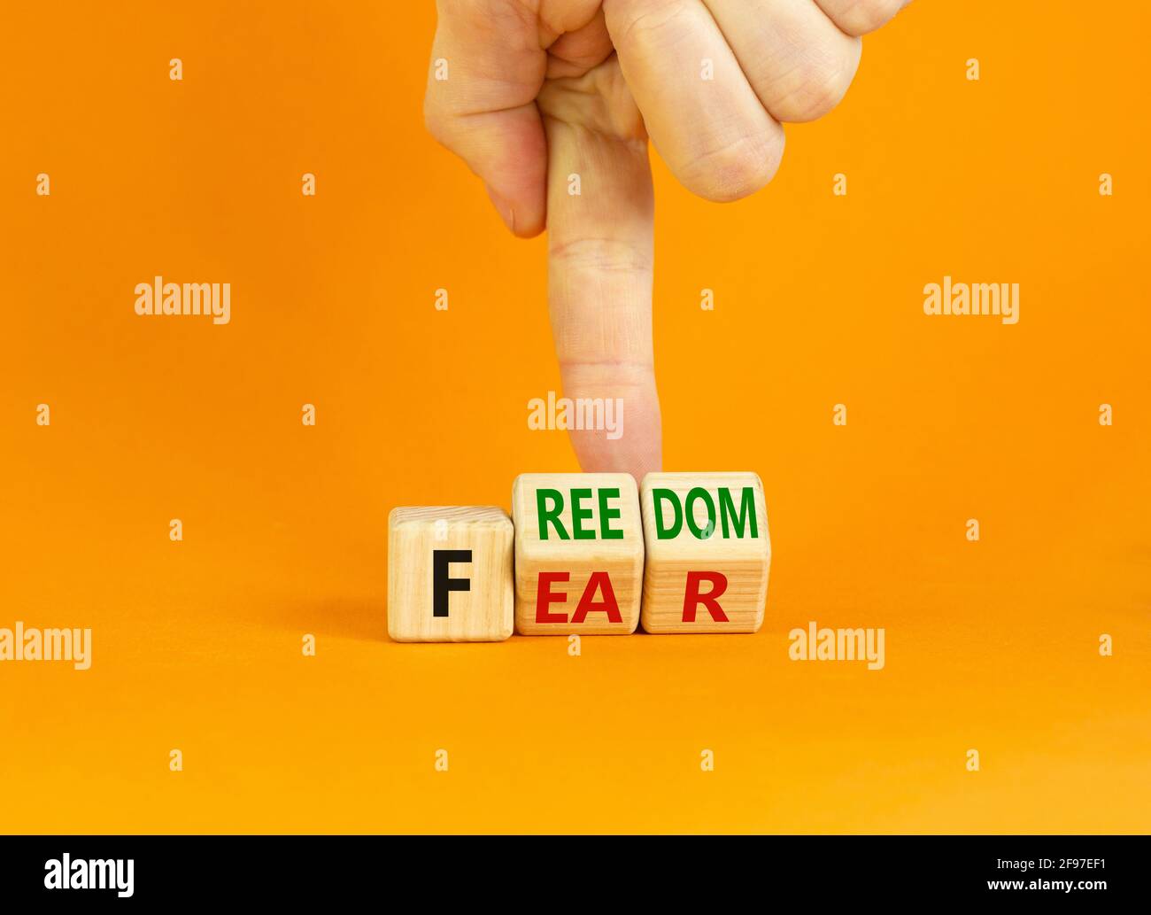 Freedom from fear symbol. Businessman turns wooden cubes and changes ...