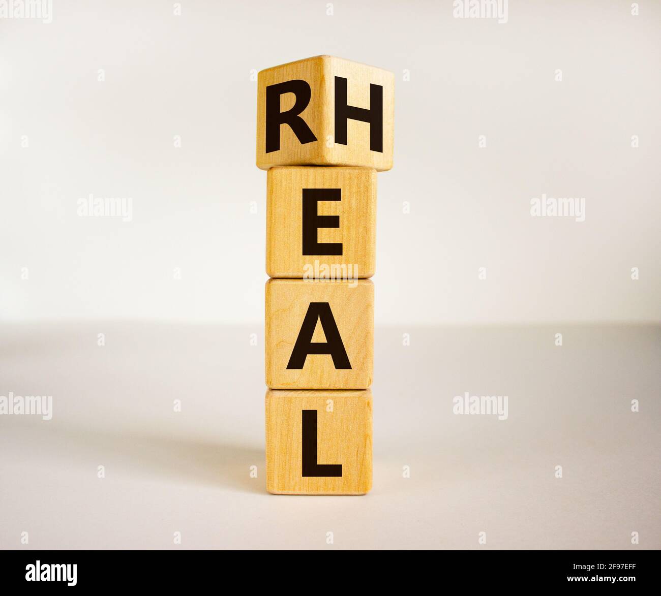 Real heal symbol. Turned cubes with words 'Real heal'. Beautiful white ...