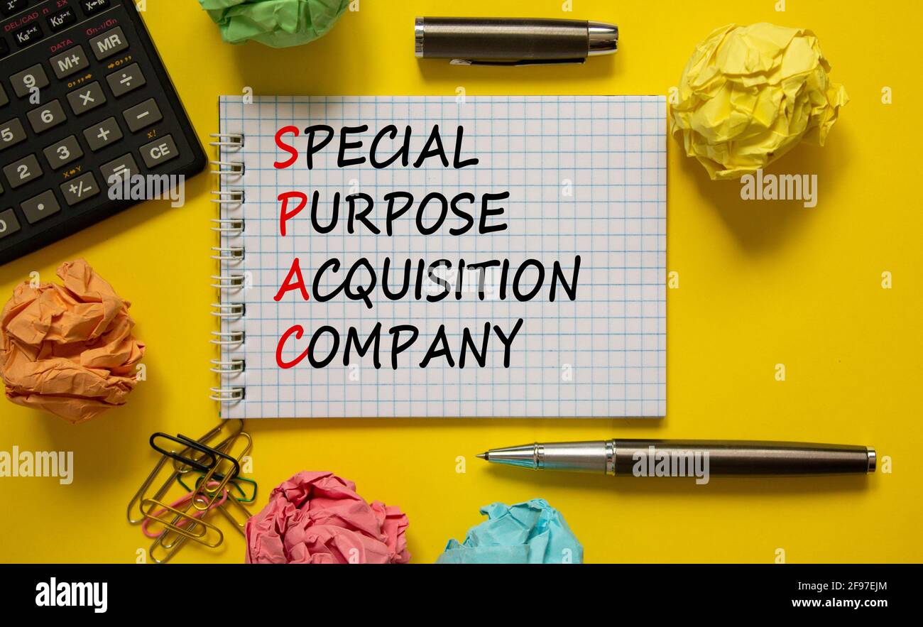 SPAC, special purpose acquisition company symbol. White note with words ...