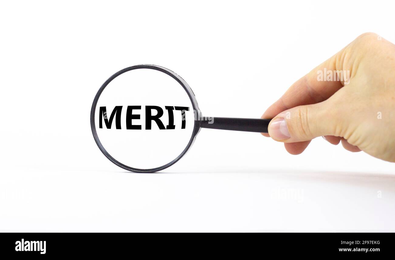 Merit symbol. Magnifying glass with word merit on a beautiful white ...