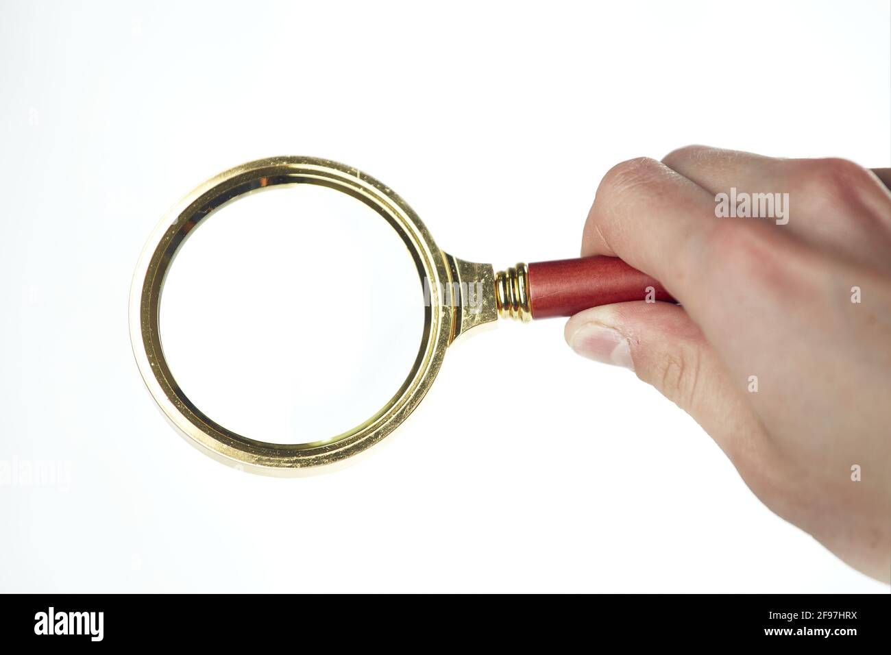 Magnifier in hand isolated on white background Stock Photo - Alamy