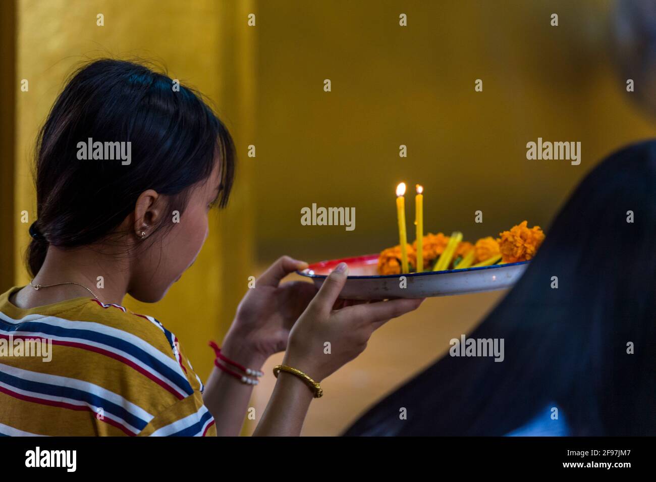 Laos, Vientiane, the Vat Simuang temple, woman, praying, tray, candles ...