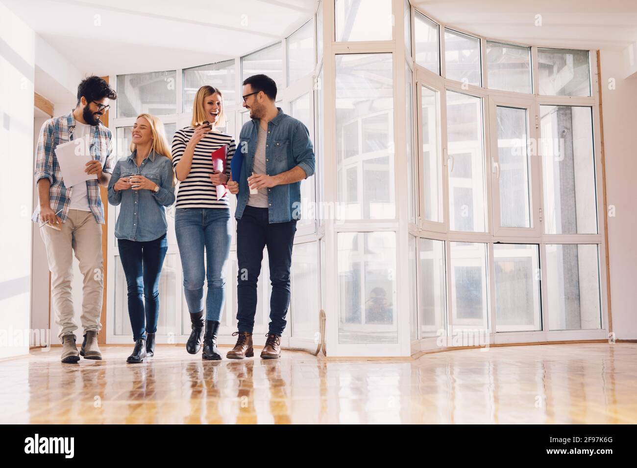 Male friends talking hallway hi-res stock photography and images - Alamy