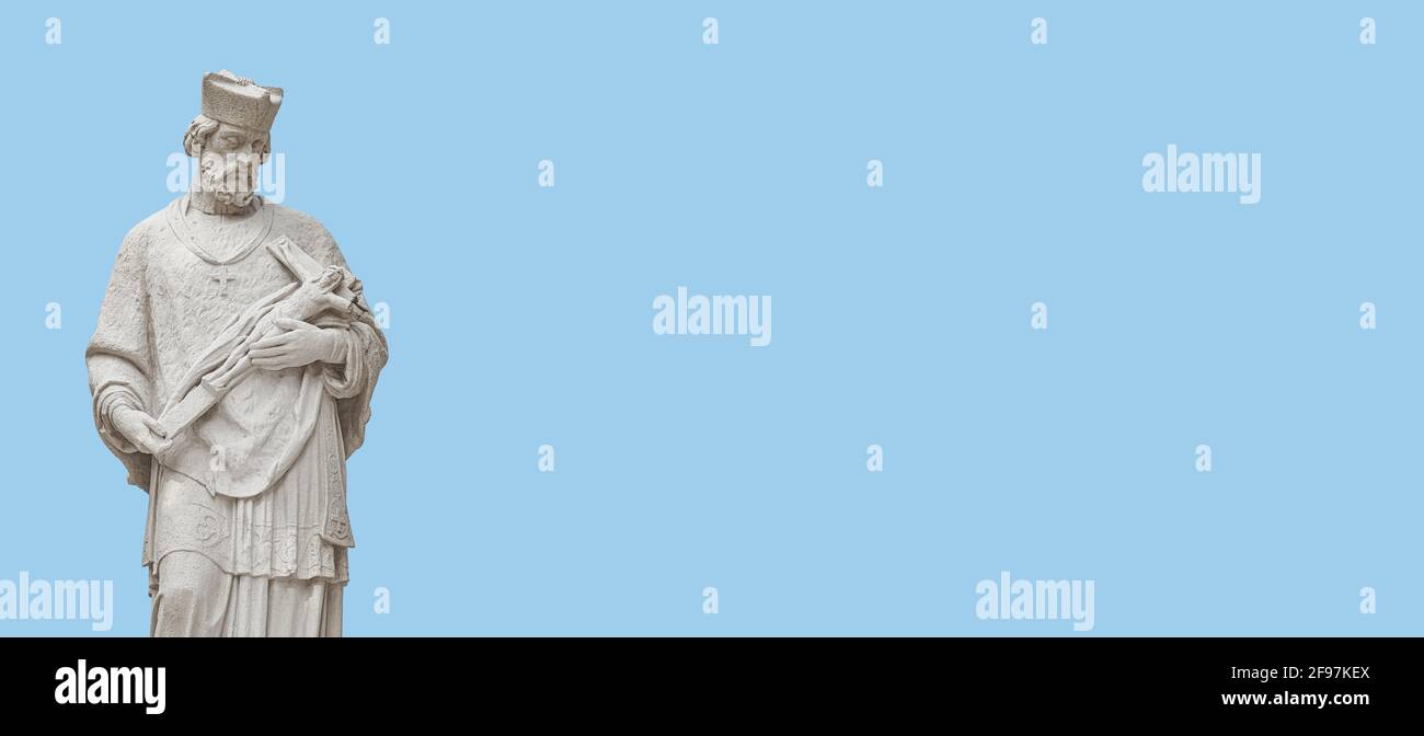 Banner with a statue of priest with figure of crucified Jesus in Vienna ...