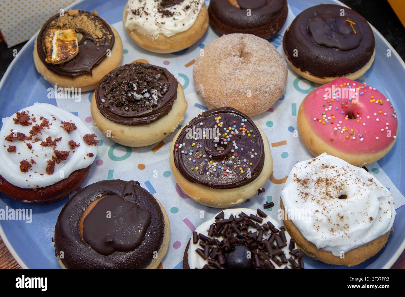 A delicious selection of colourful doughnuts including a chocolate one ...