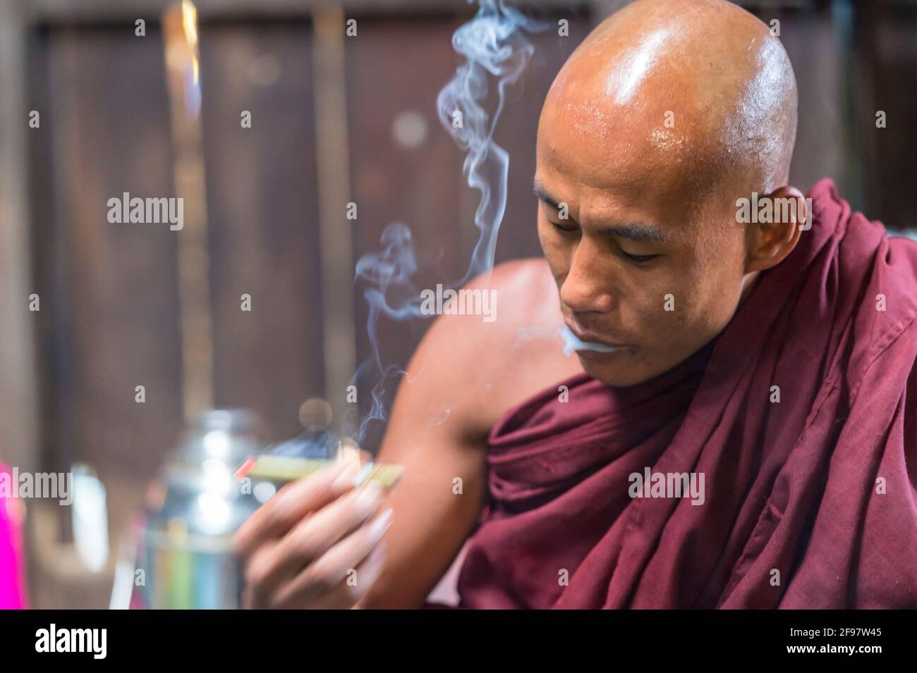 Myanmar, scenes at Inle lake, Phyu Nge monastery, monk, smoking ...