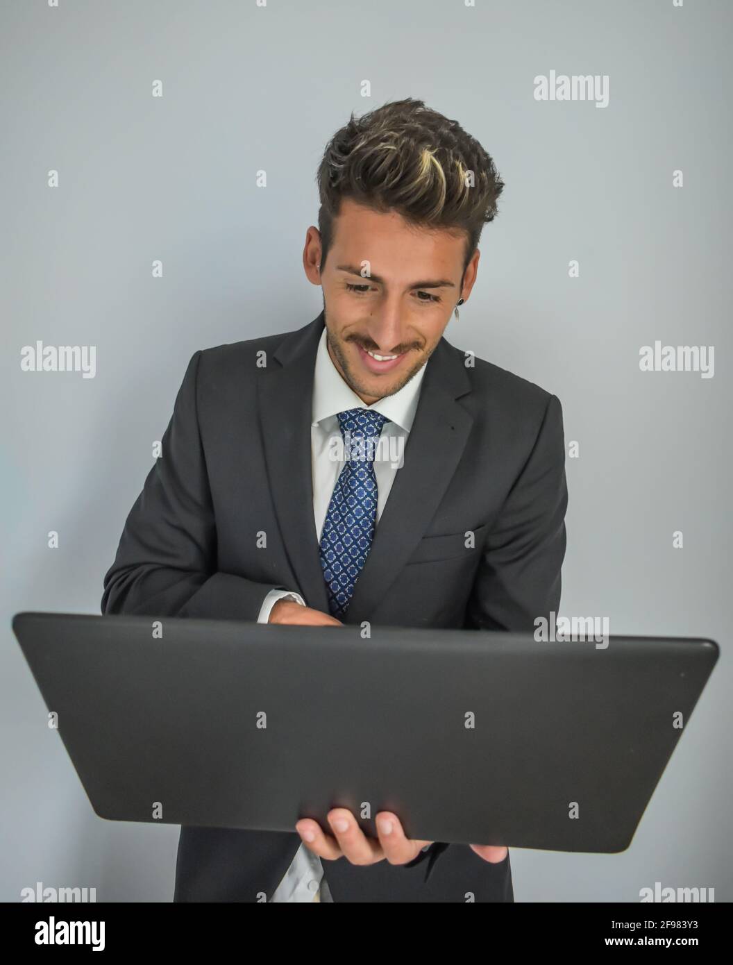 Spanish businessman in a suit smiling while having a conversation over ...