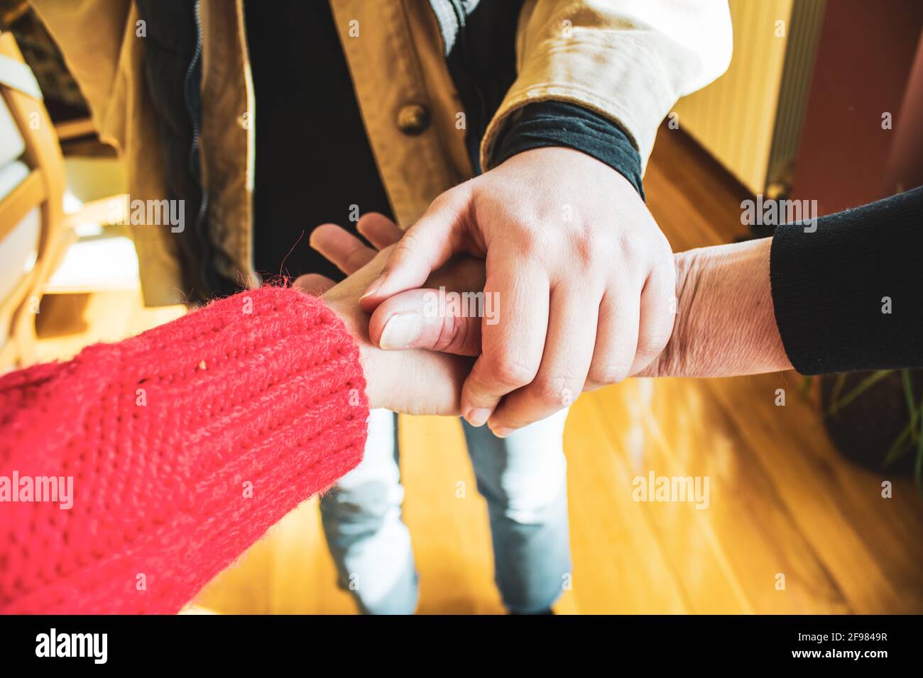 Three hands clasped hi-res stock photography and images - Alamy