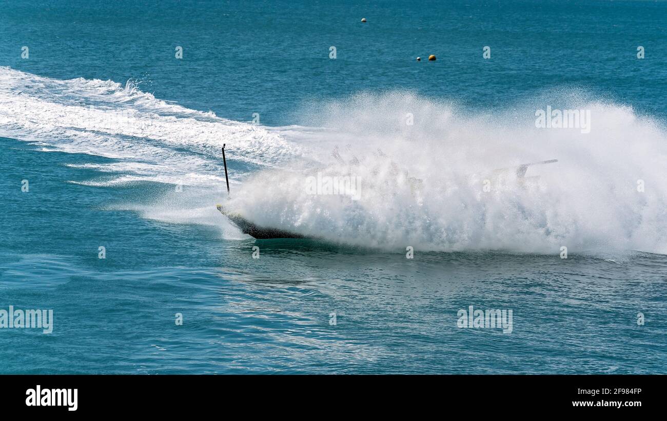 Thick ocean spray hides a spinning jet boat full of tourists enjoying ...