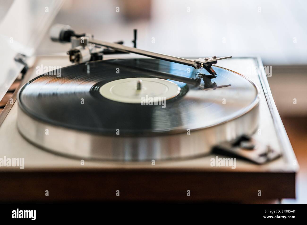 vinyl record turntable on wooden base playing a vinyl record Stock ...