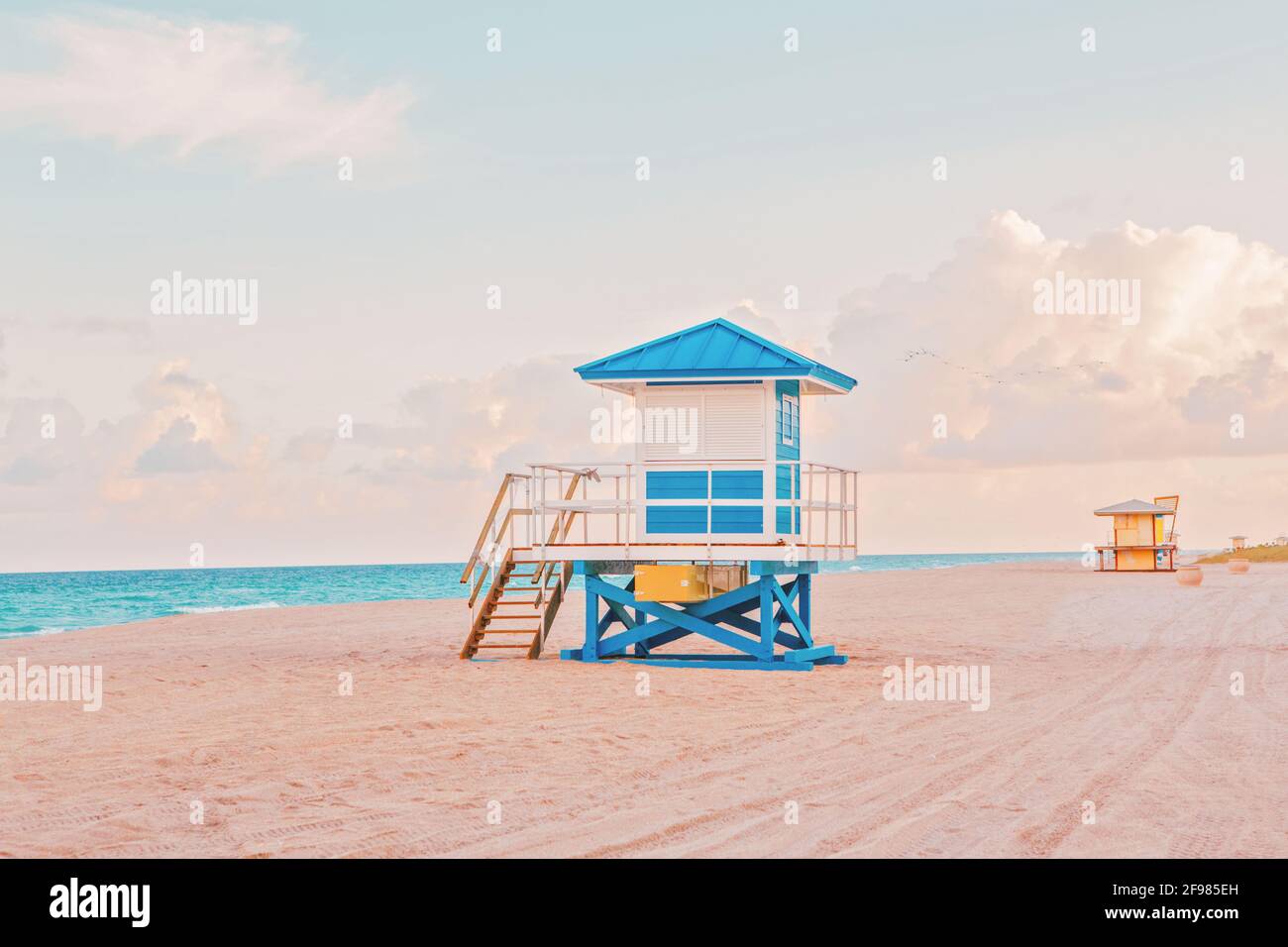Empty Florida beach with lifeguard houses on sunset. Airy light nature ...