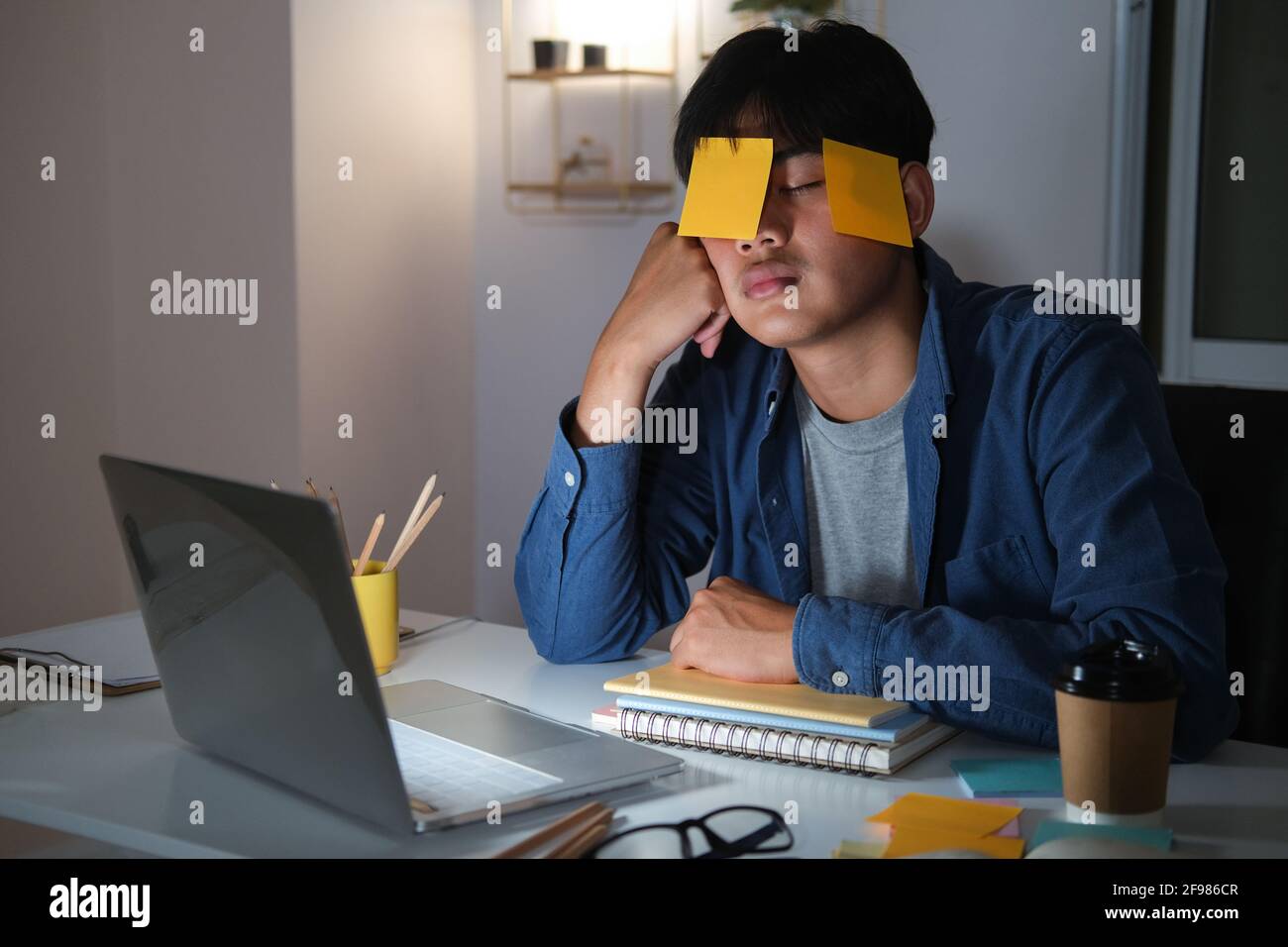 Exhausted tired workaholic young man with sticky note Stock Photo - Alamy