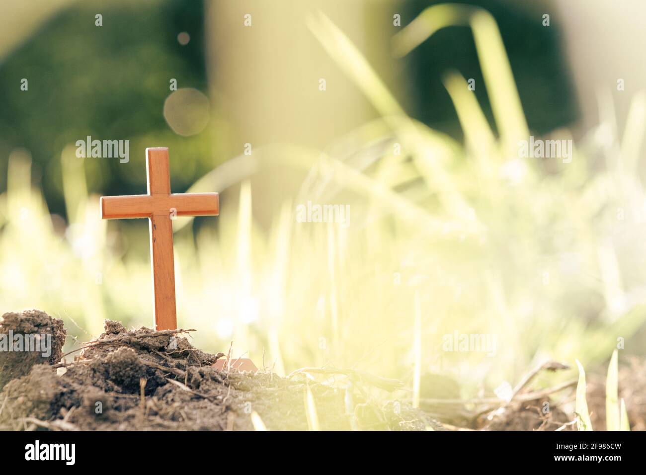 Cross on blurry sunset background Stock Photo - Alamy