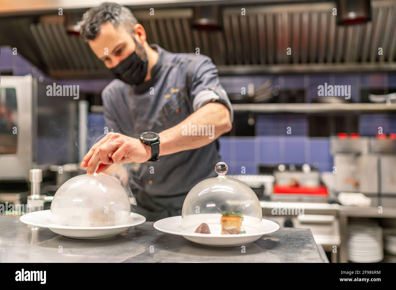 kitchen chef raising a plate of meat Stock Photo - Alamy