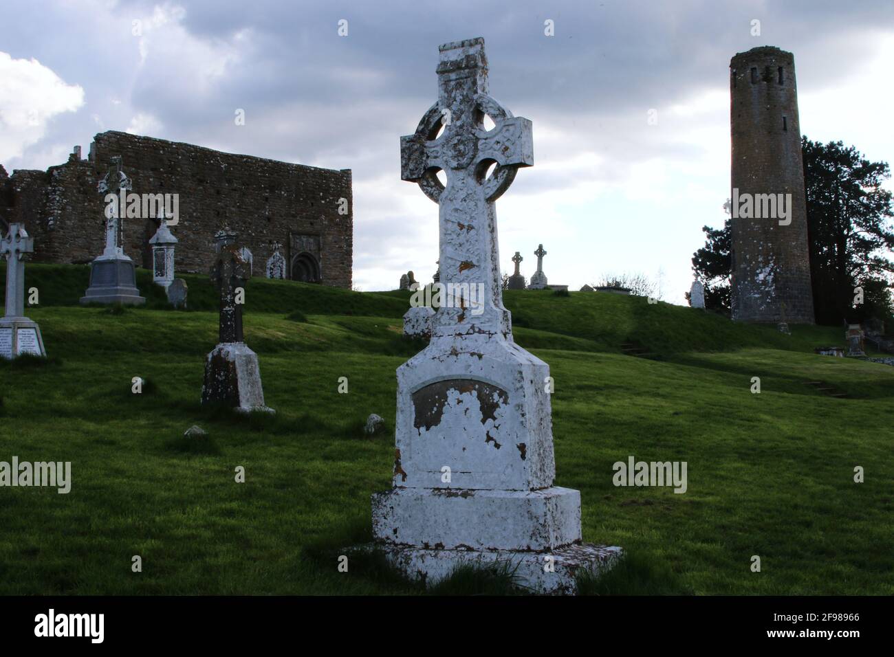 Clonmacnoise Cathedral with the typical crosses and graves. The ...