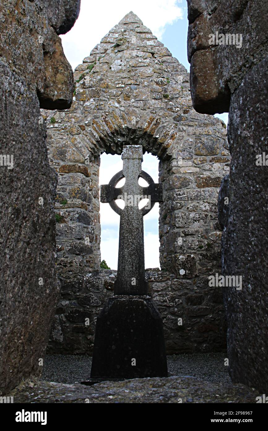 Clonmacnoise Cathedral with the typical crosses and graves. The ...