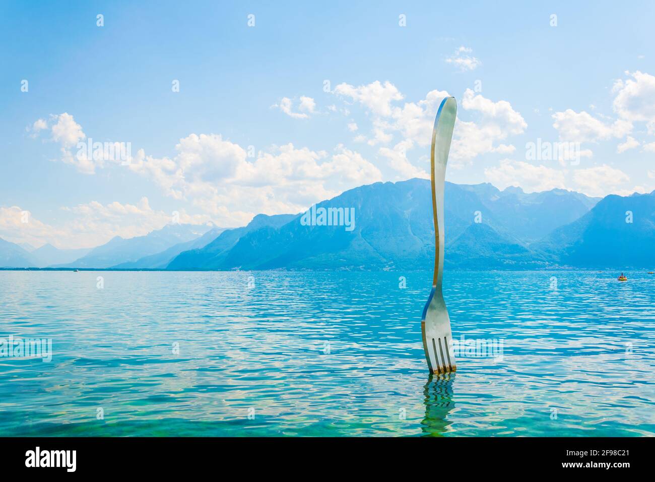 Statue of a giant fork stitched into the Geneva lake in Switzerland ...