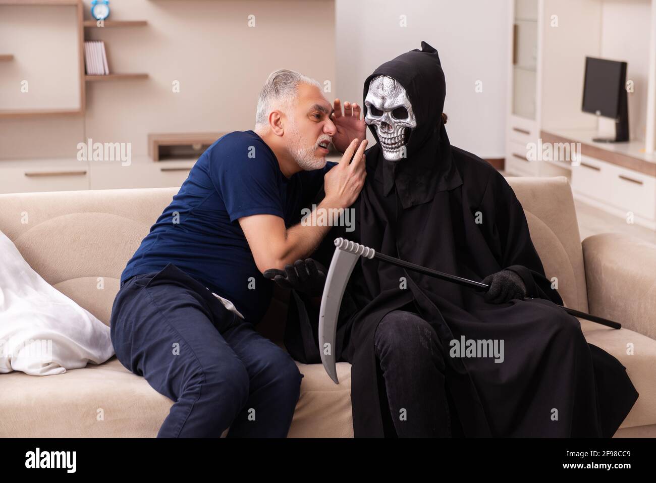 Devil coming to old dying man Stock Photo - Alamy