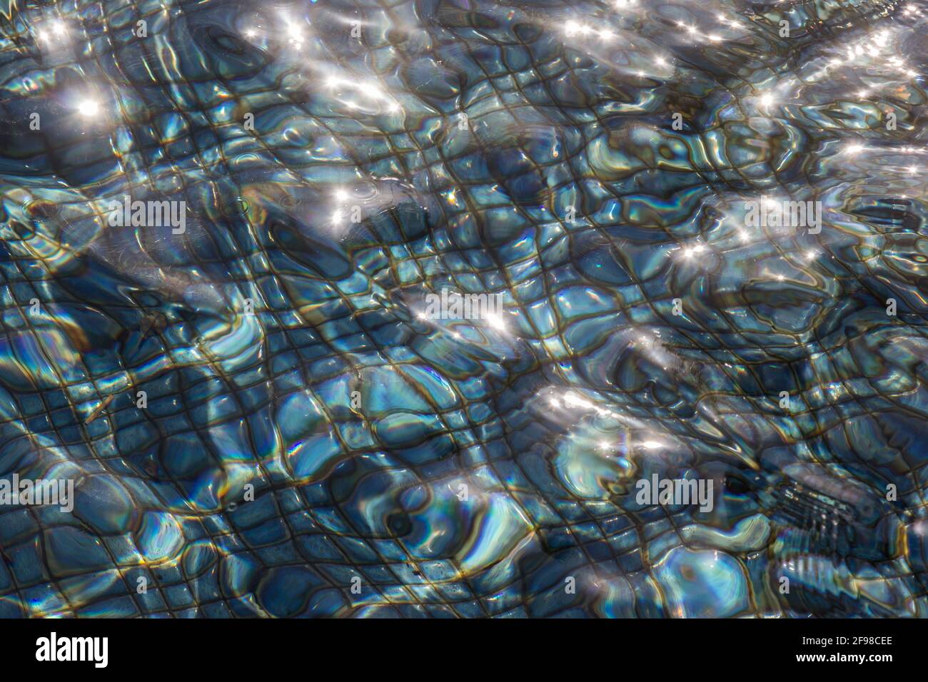 Background texture of a pool with clear shiny water and blue striped ...