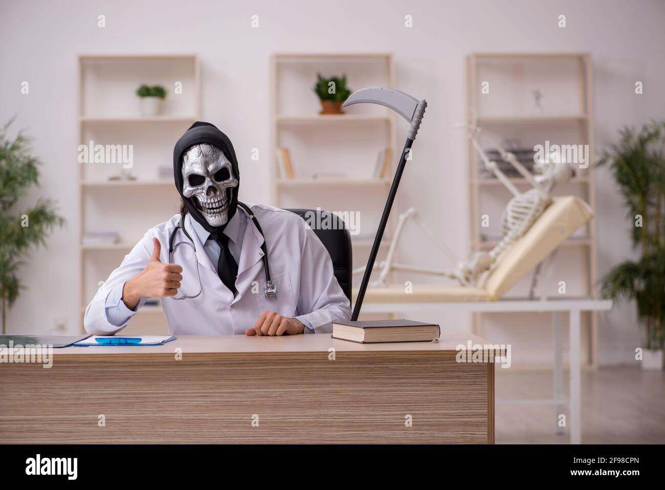 Reaper grim doctor examining skeleton patient in the clinic Stock Photo ...