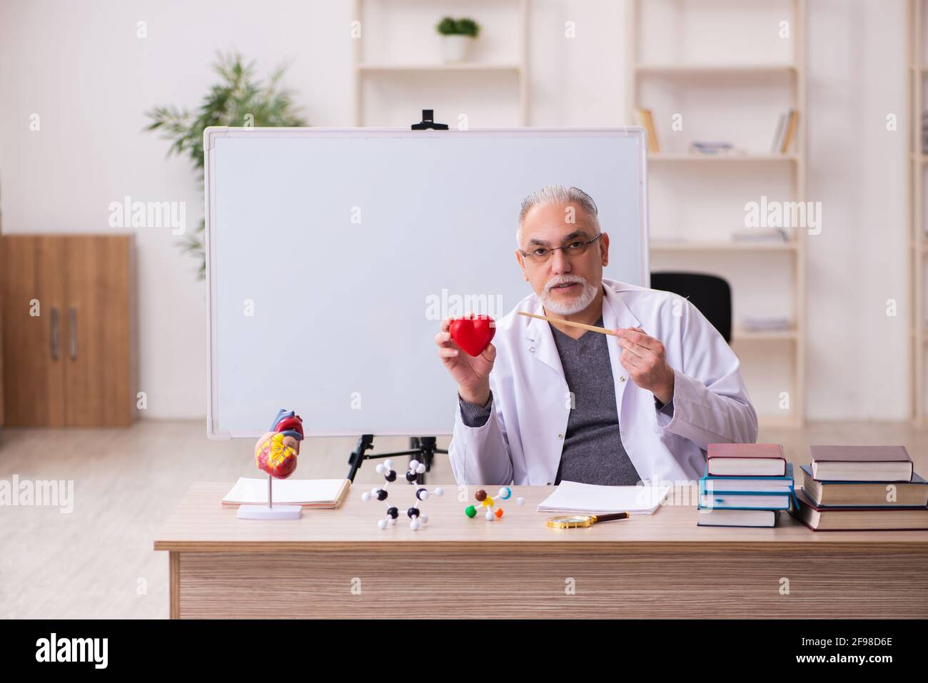 Old doctor cardiologist sitting in the classroom Stock Photo - Alamy