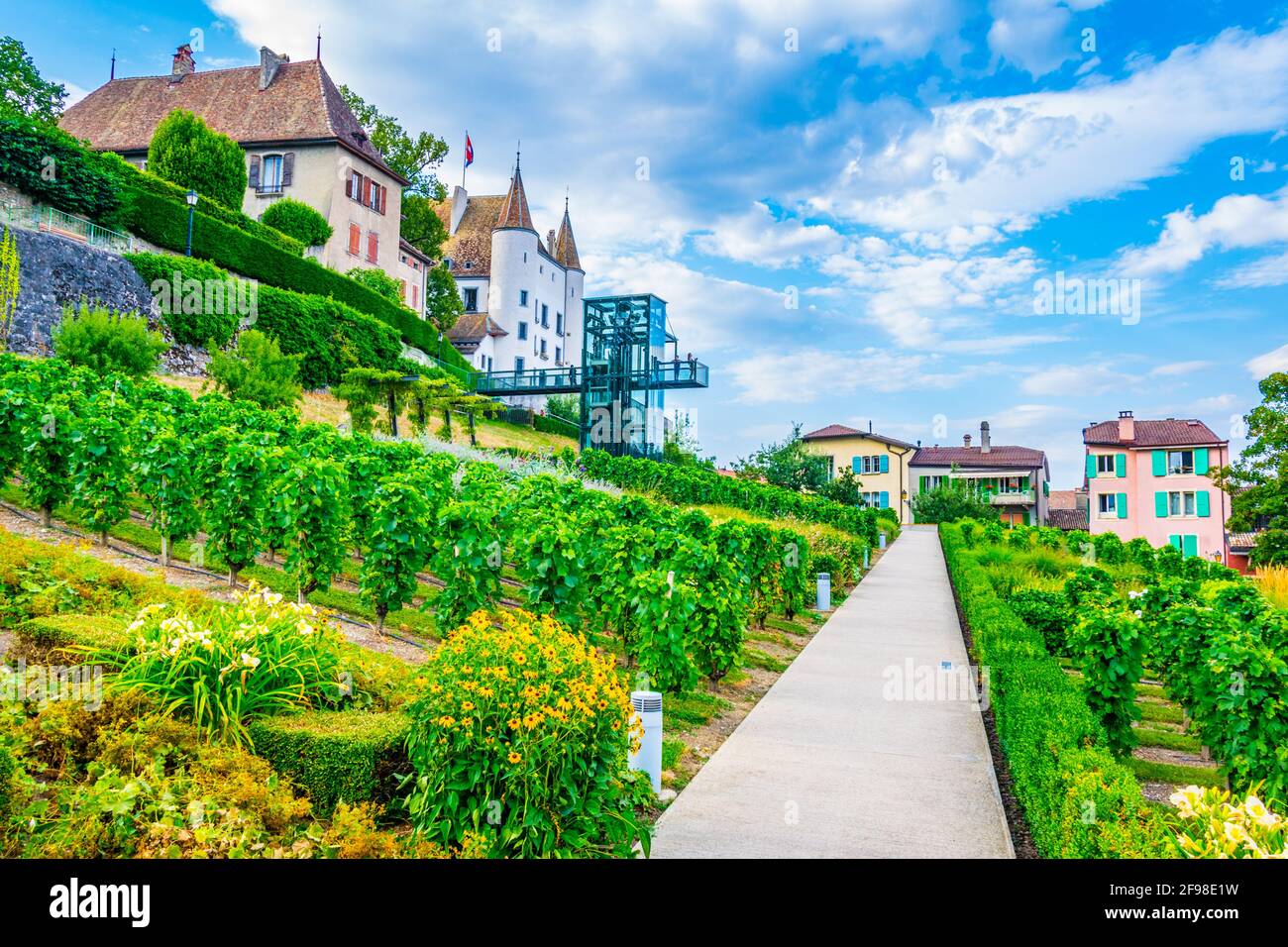 White Chateau de Nyon in Switzerland viewed behind a green garden Stock ...