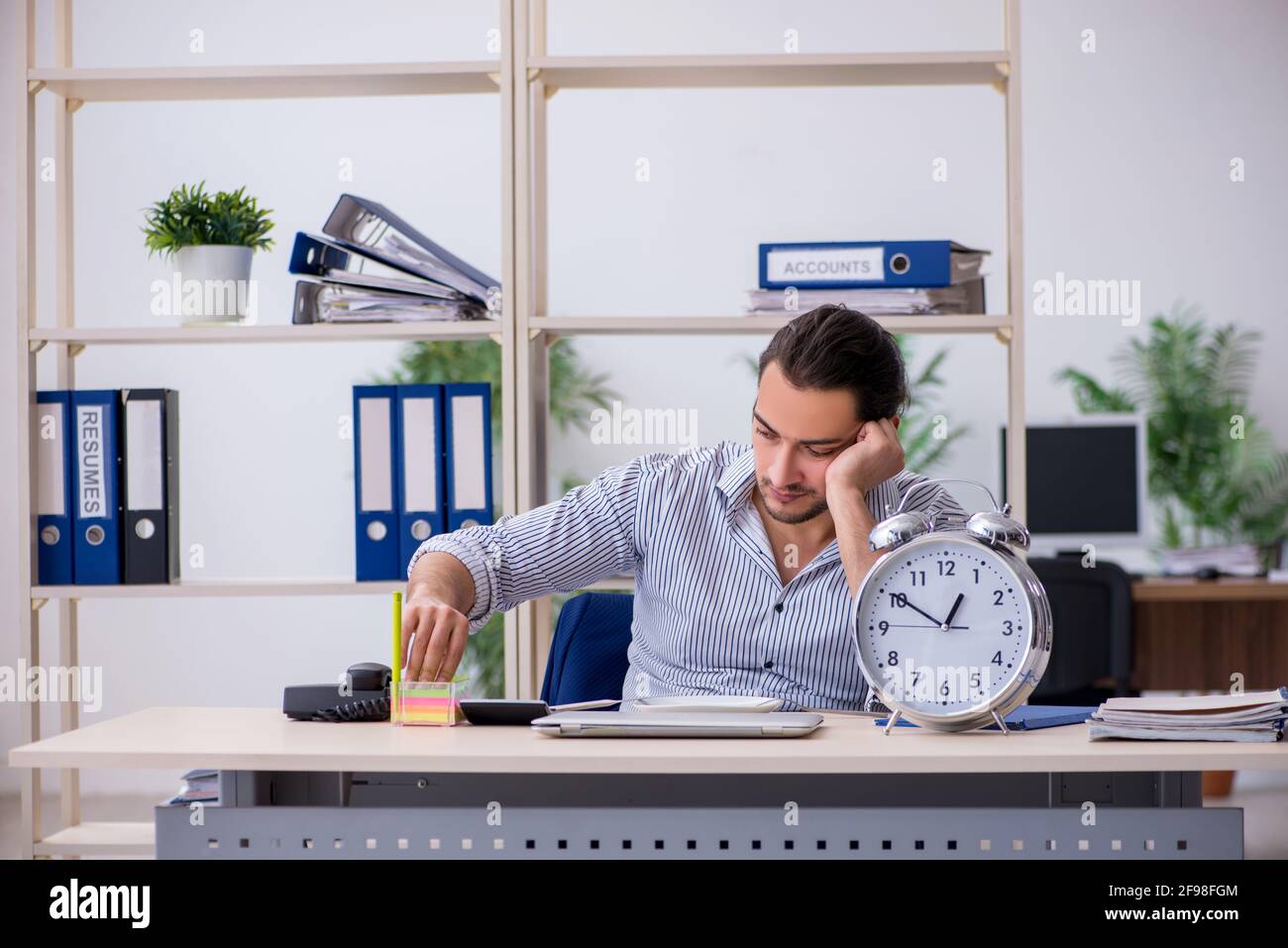 Hungry employee waiting for food in time management concept Stock Photo ...