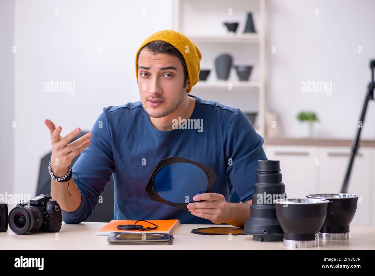 Photographer in studio adjusting dslr hi-res stock photography and ...