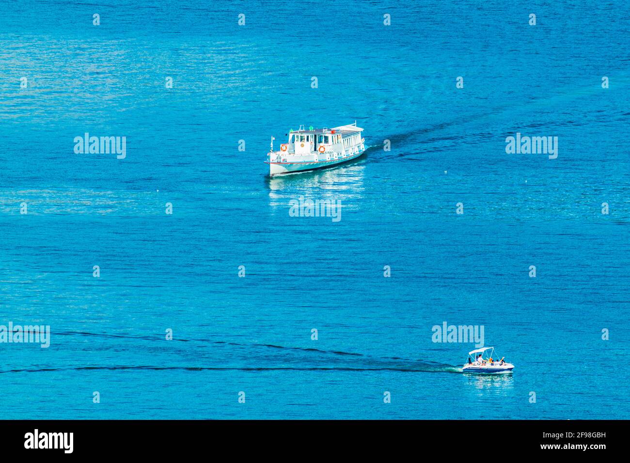 Passenger ferry is arriving to the pier at port at Lugano, Switzerland ...