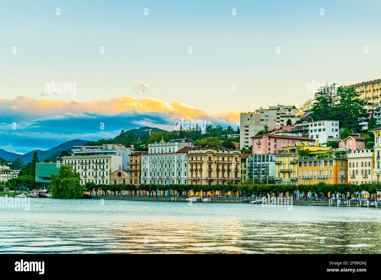Sunset view of old town of Lugano facing the Lugano lake in Switzerland ...