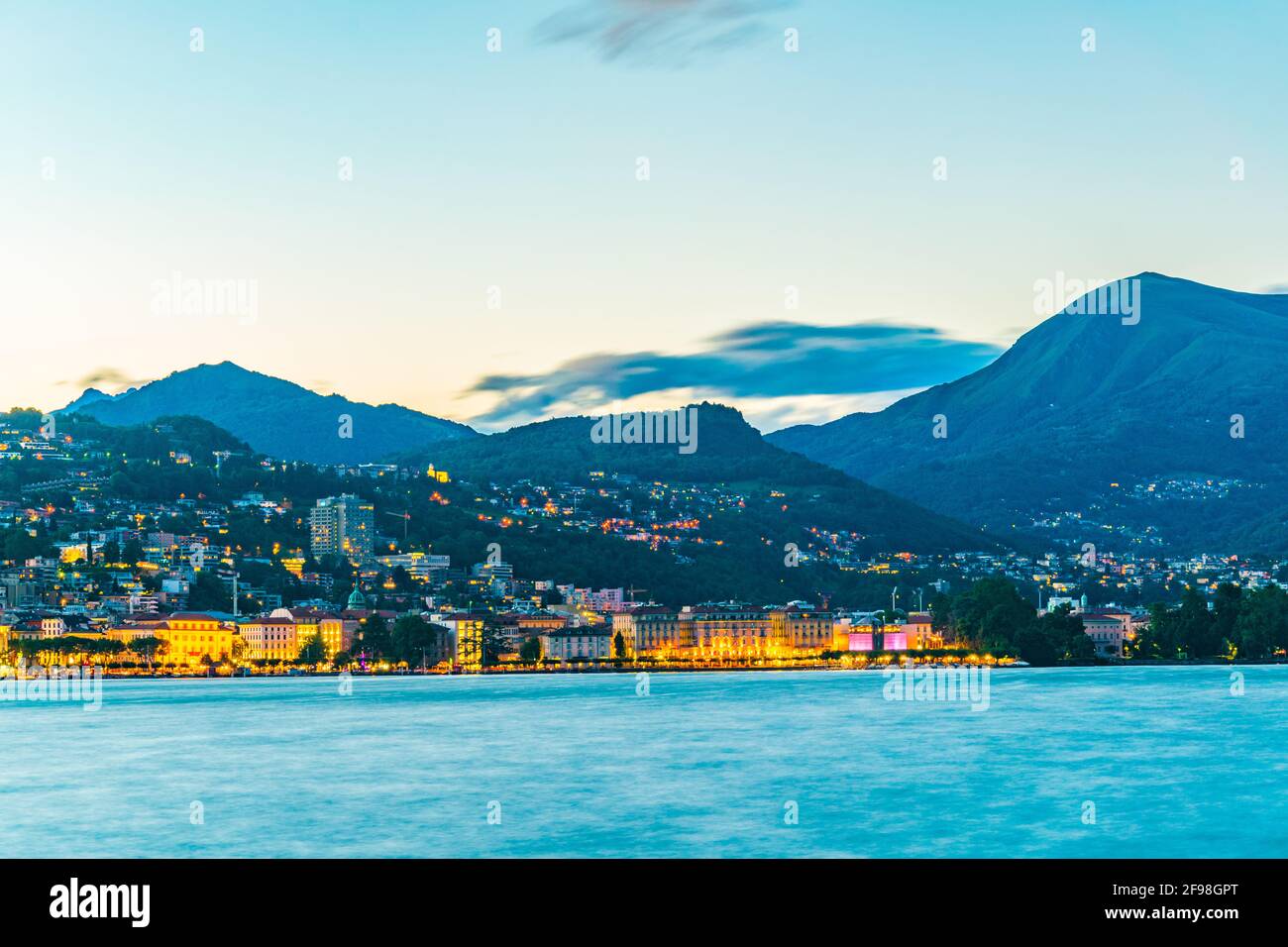 Sunset view of old town of Lugano facing the Lugano lake in Switzerland ...