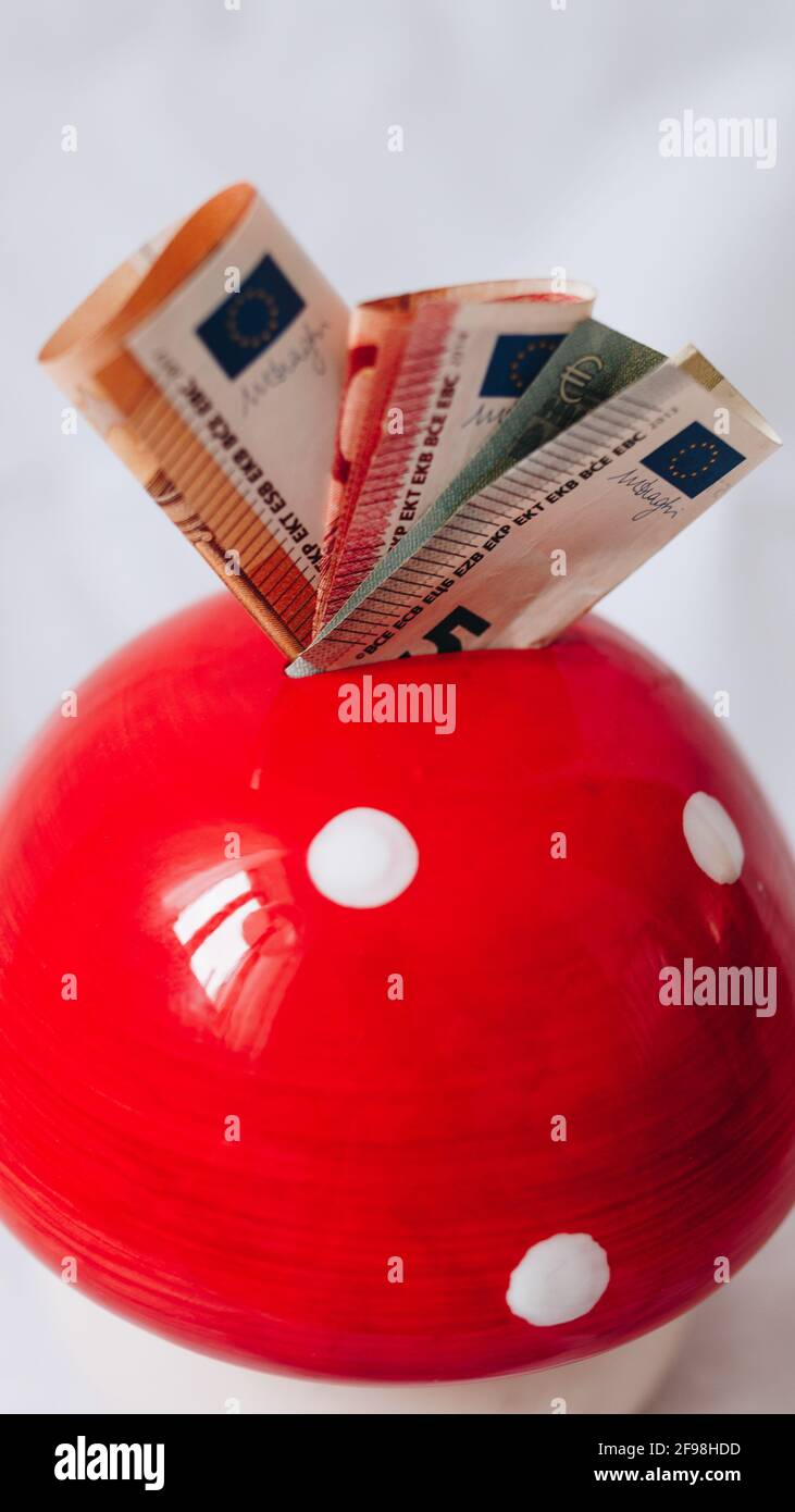 Mushroom as a money box, bank notes, euros, save Stock Photo - Alamy