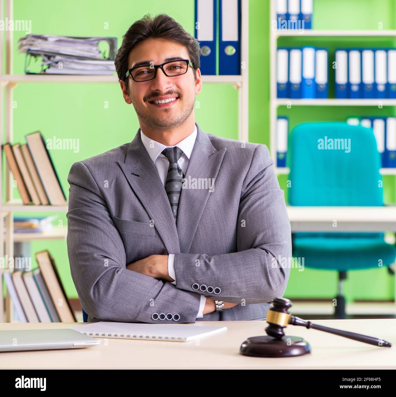 The young handsome lawyer working in the office Stock Photo - Alamy