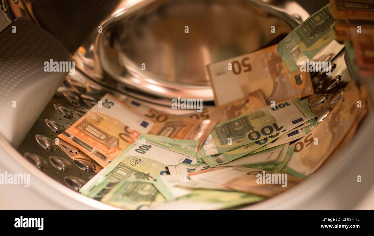 Money in washing machine, symbol money laundering Stock Photo - Alamy