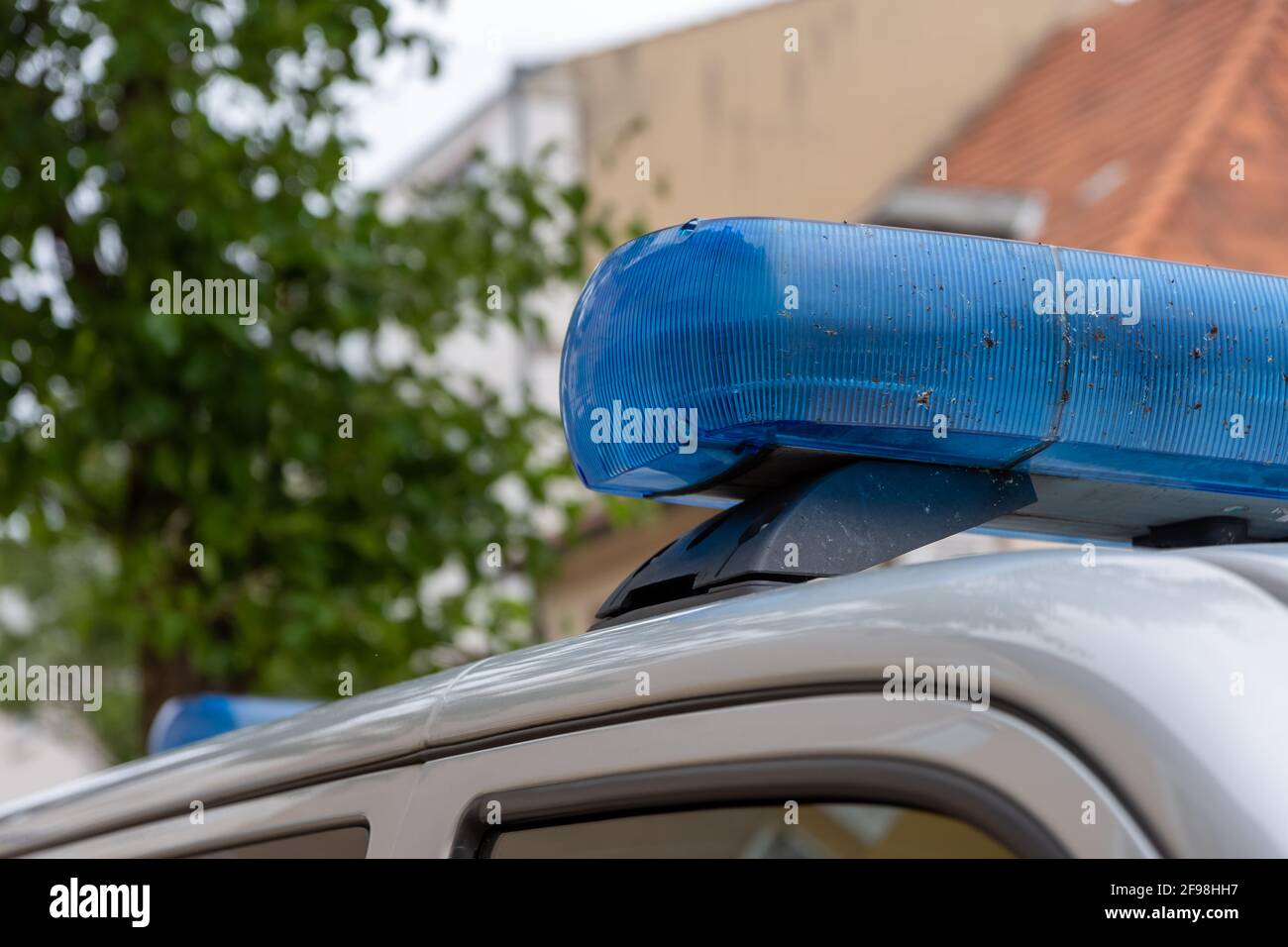 Closeup of a siren on a police car, parked outside during daylight ...