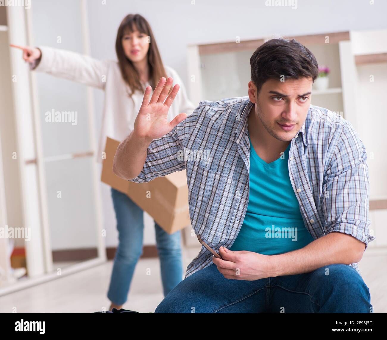The woman evicting man from house during family conflict Stock Photo ...