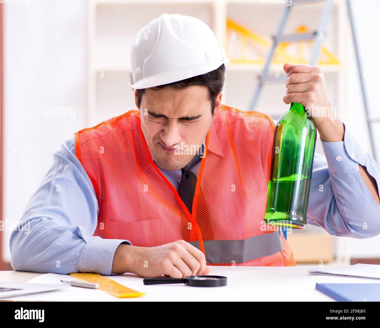 The drunk engineer working in the workshop Stock Photo - Alamy